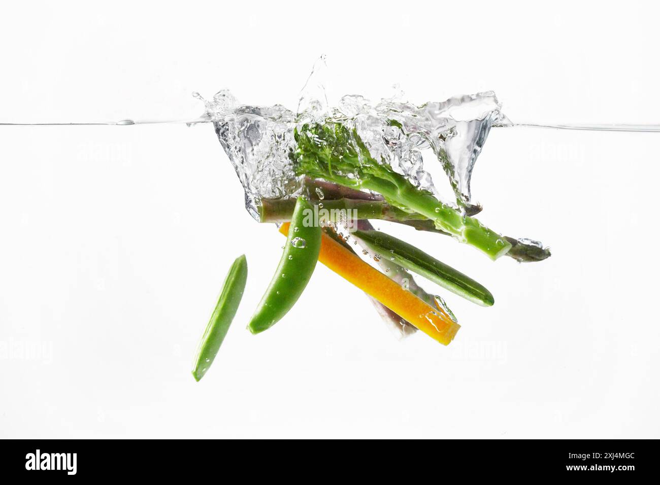 Vegetables falling in the water Stock Photo - Alamy