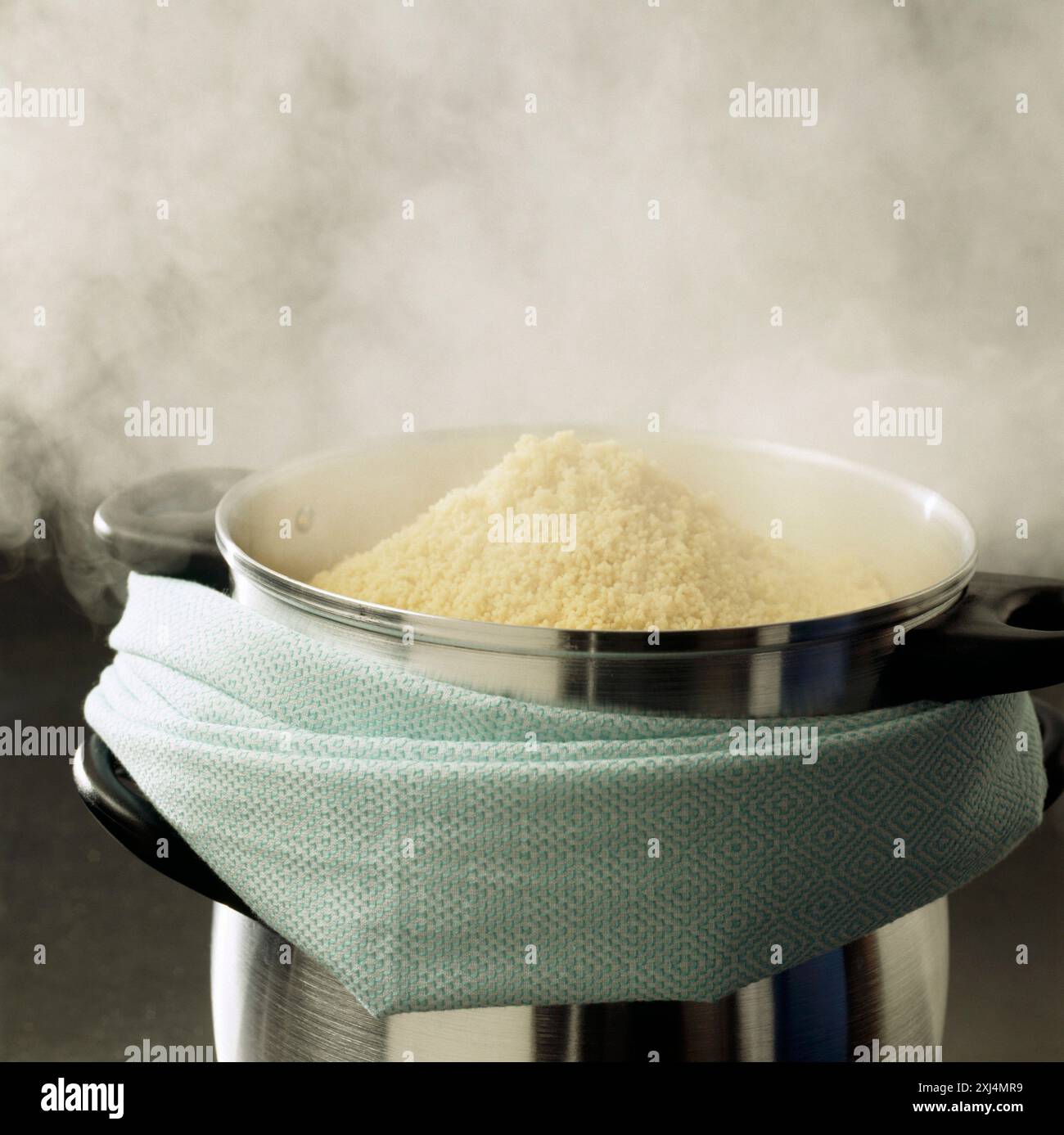 Cooking the semolina in a Couscous dish Stock Photo - Alamy