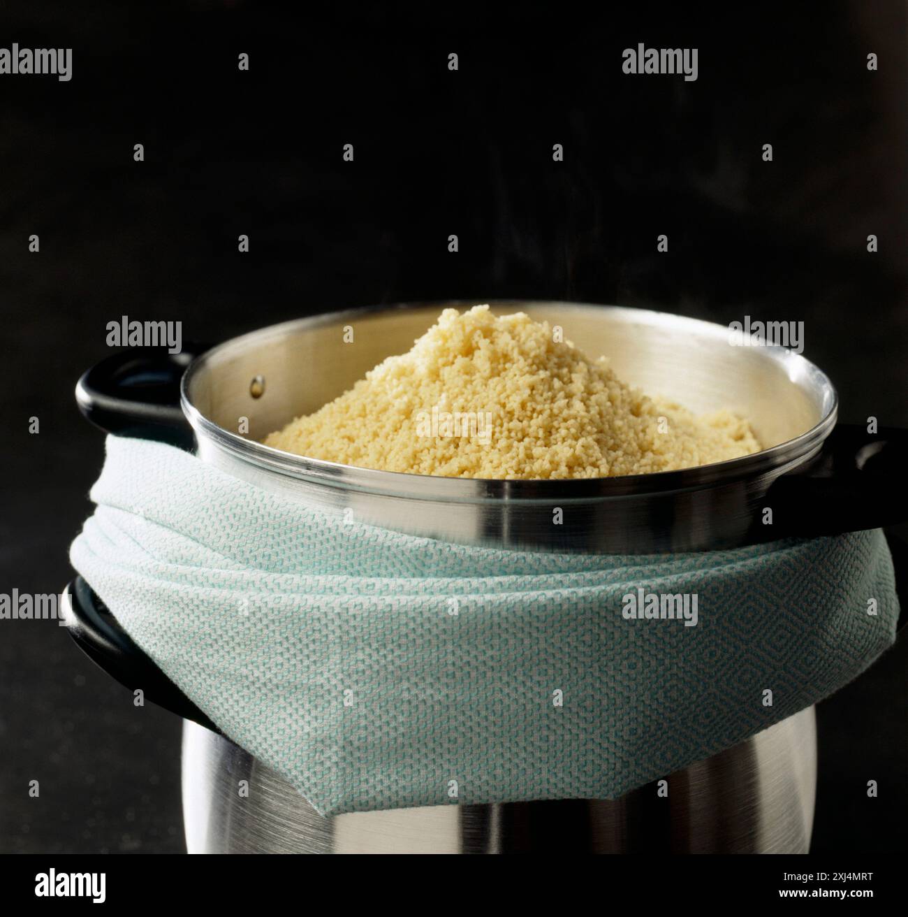Cooking the semolina in a Couscous dish Stock Photo - Alamy