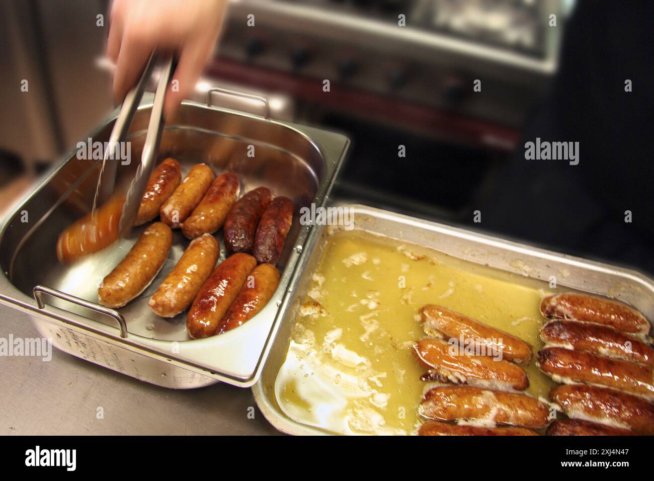Draing the sausages cooked in grease Stock Photo - Alamy