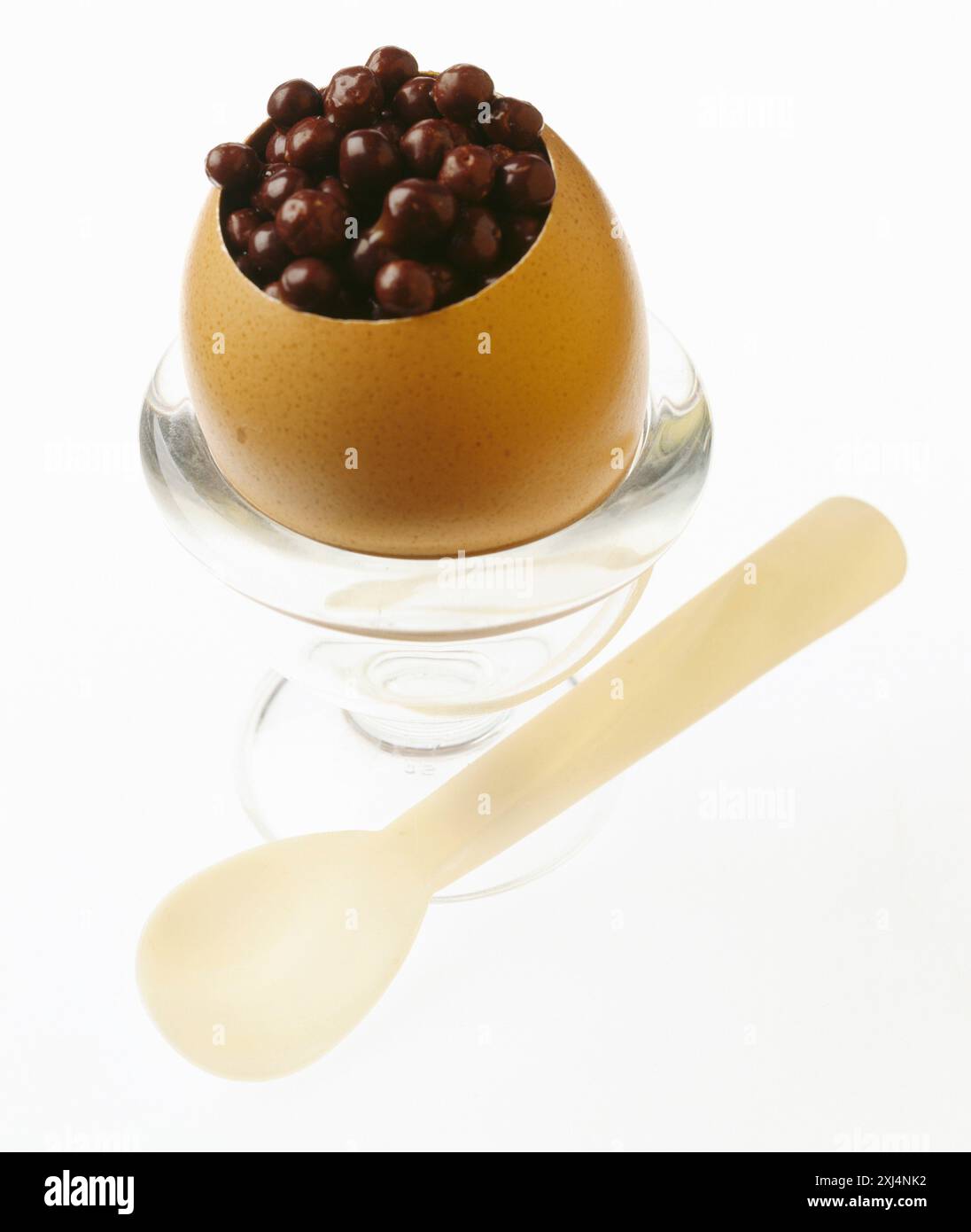 Egg shell filled with chocolate pearls Stock Photo - Alamy