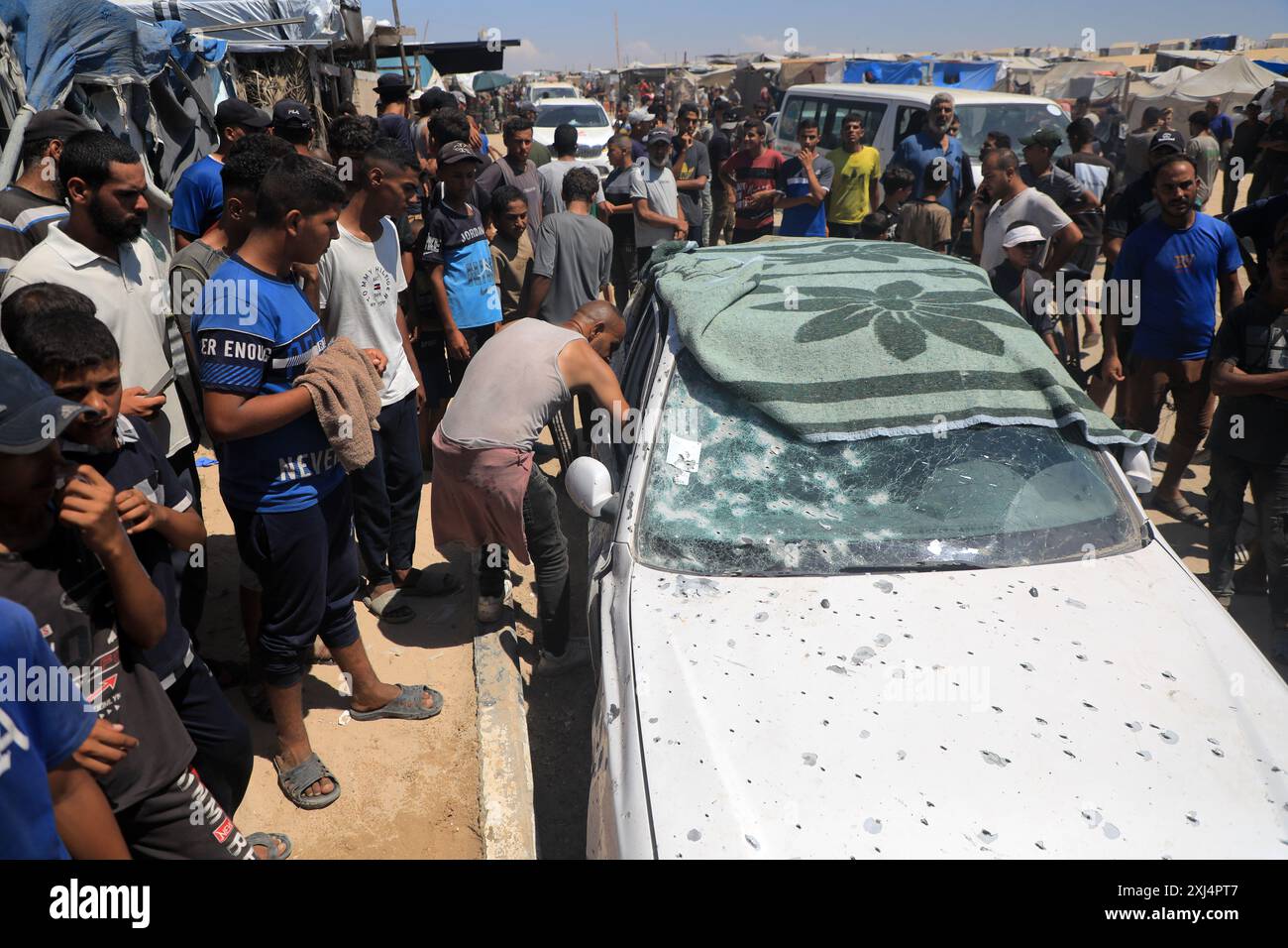 Al Mawasi. 16th July, 2024. Palestinian people inspect a damaged car ...