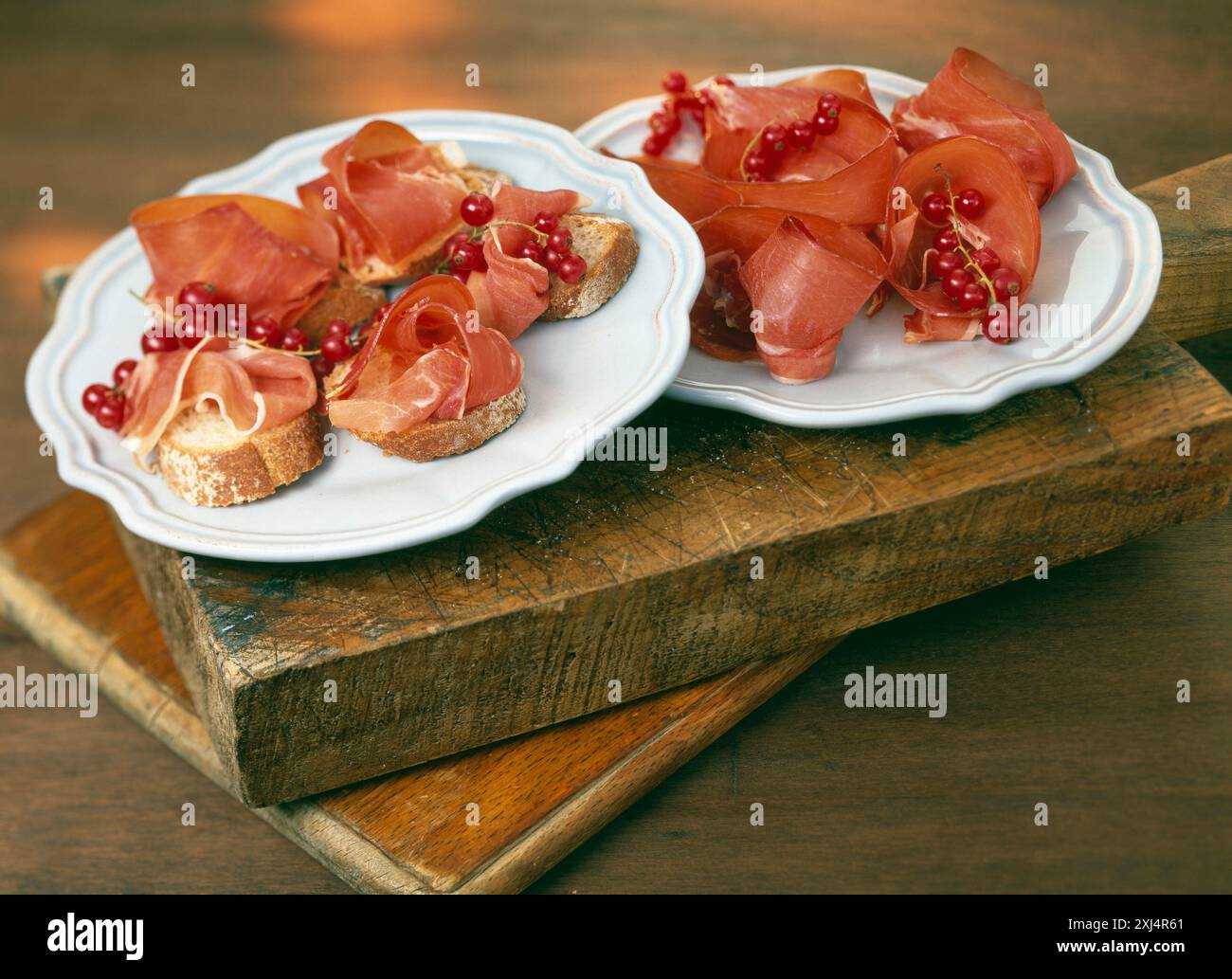Raw ham and redcurrant open sandwiches Stock Photo - Alamy