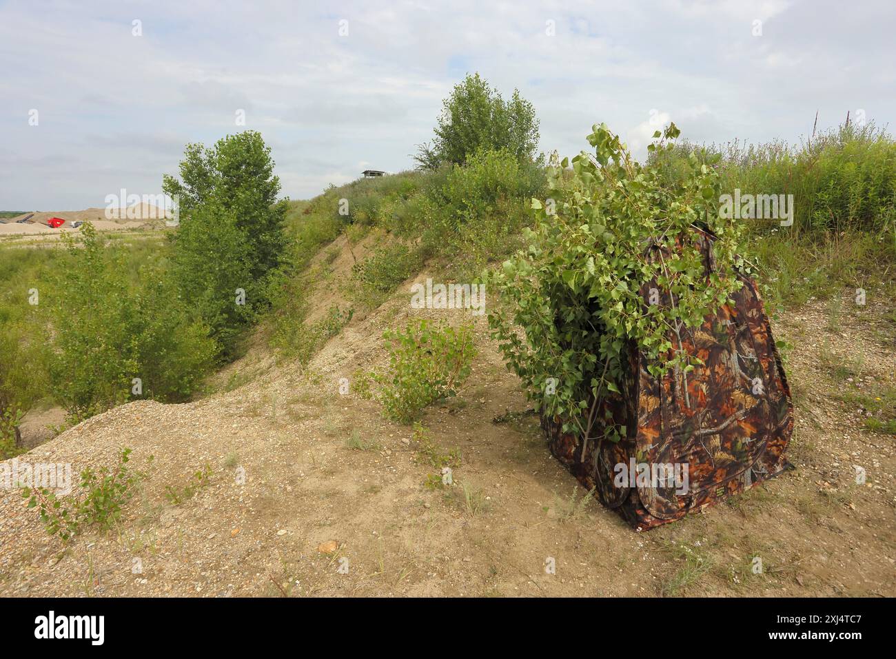 Camouflage tent of a nature photographer in a sand pit, camouflage ...