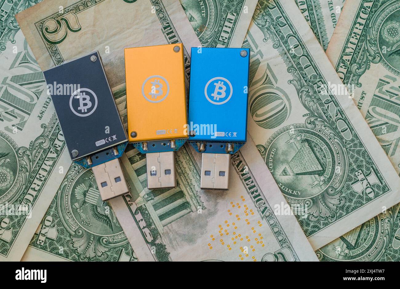 Blue and yellow USB hardware wallets with Bitcoin logos placed on US ...