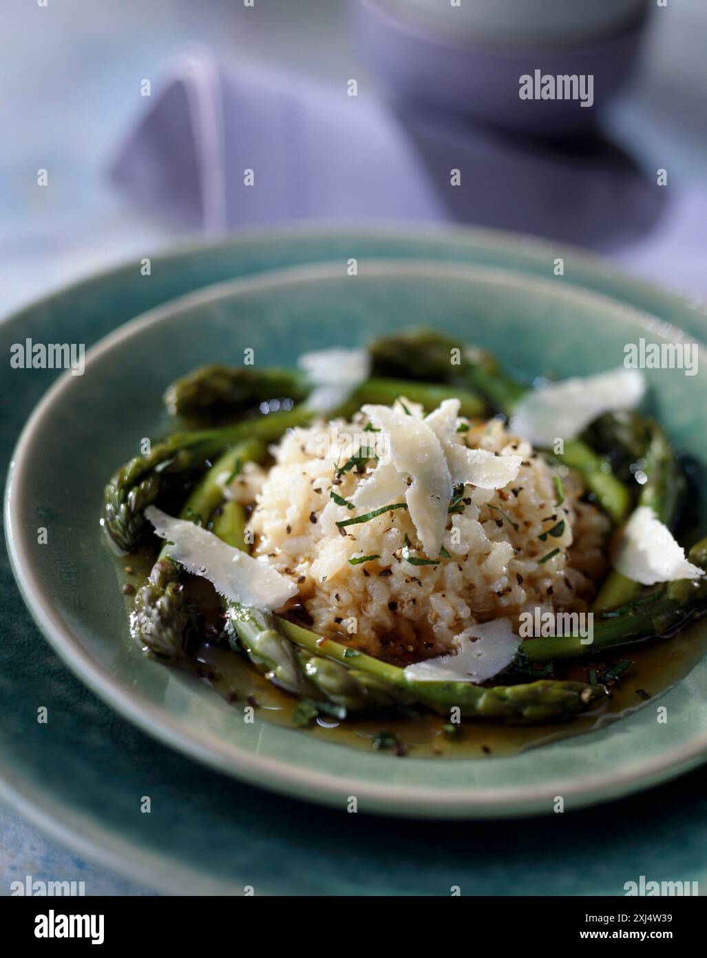 Risotto with green asparagus and parmesan flakes Stock Photo - Alamy