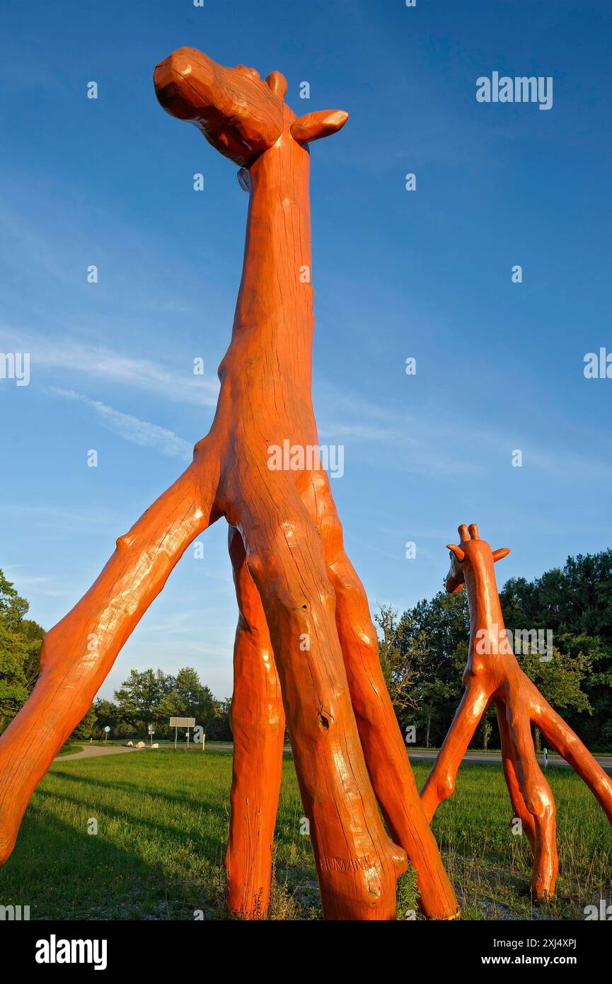 Giraffes made of red painted tree trunks, wooden sculpture by Guenter ...