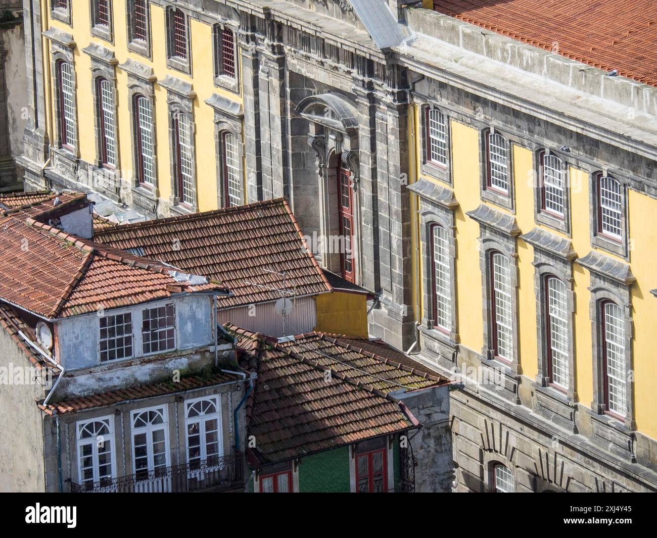 Historic yellow buildings with many large windows and red tiled roofs ...