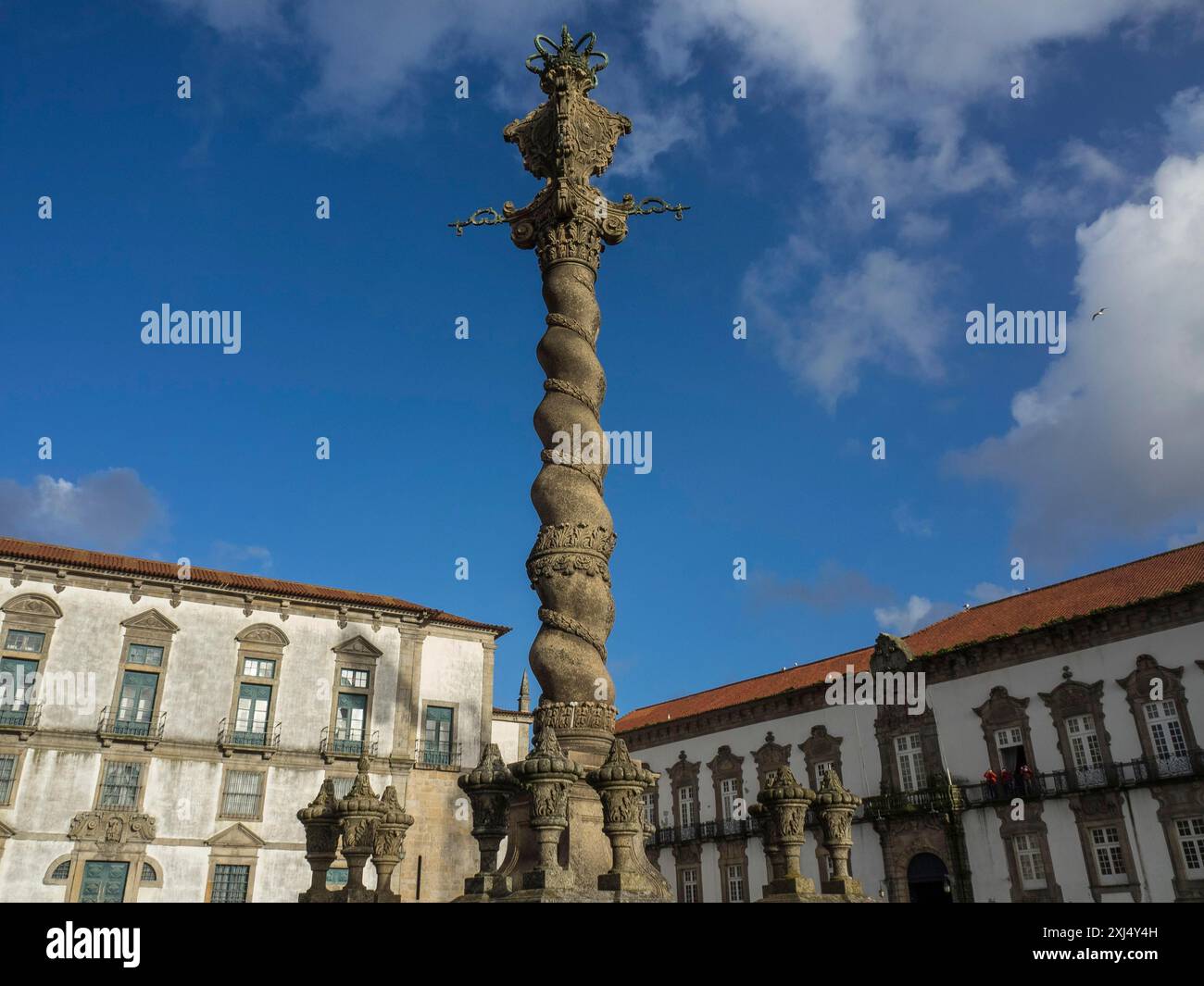 Tall, twisted stone column as a monument in the centre of historic ...