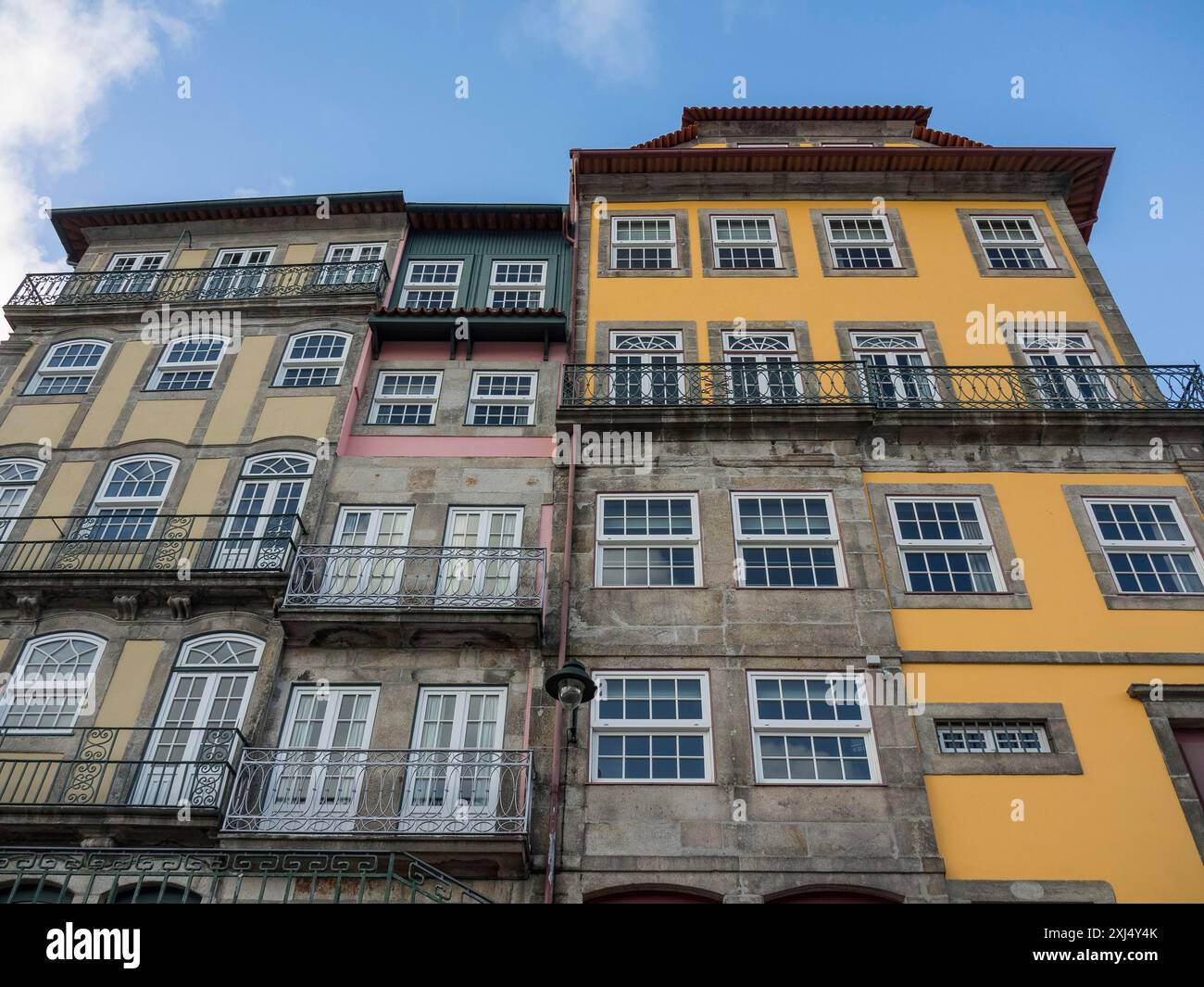 Colourful facades of historic buildings with balconies and many windows ...
