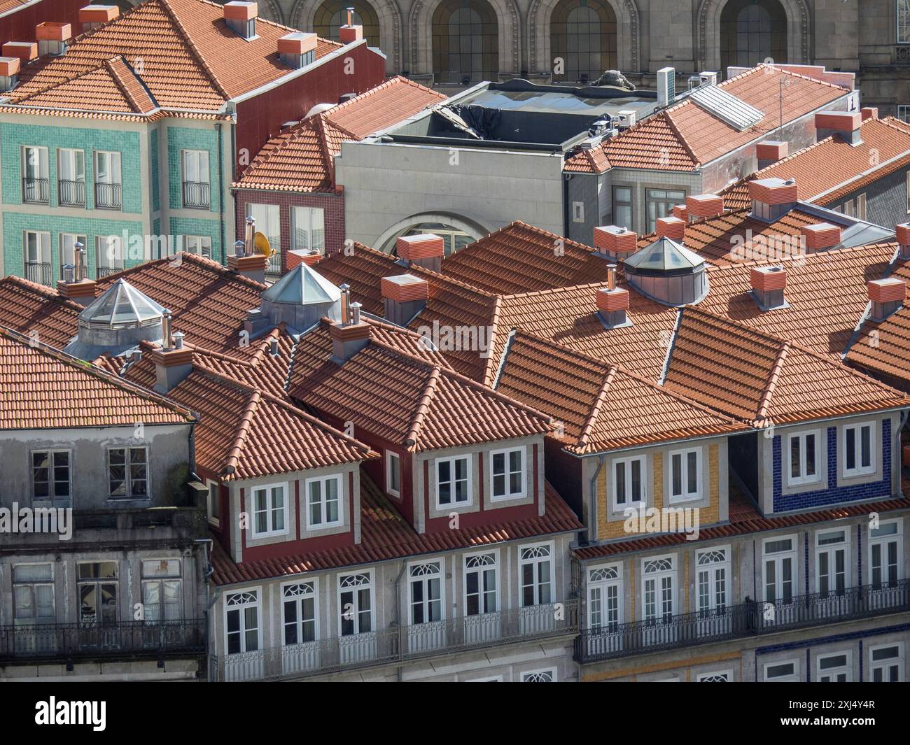 Roofs and upper floors of old, colourful buildings in a city with tiled ...