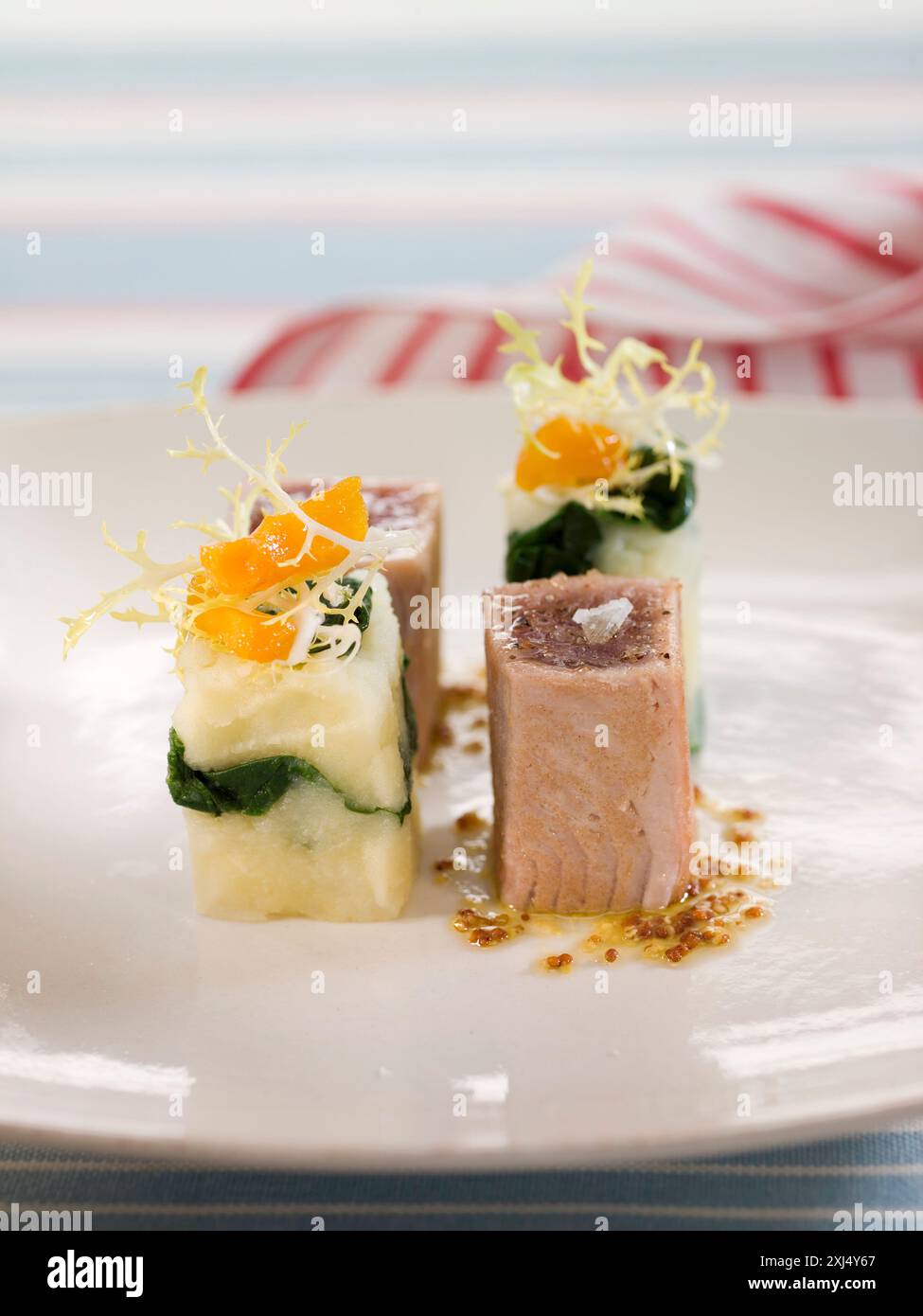 Cubes of white tuna and spinach puree Stock Photo - Alamy