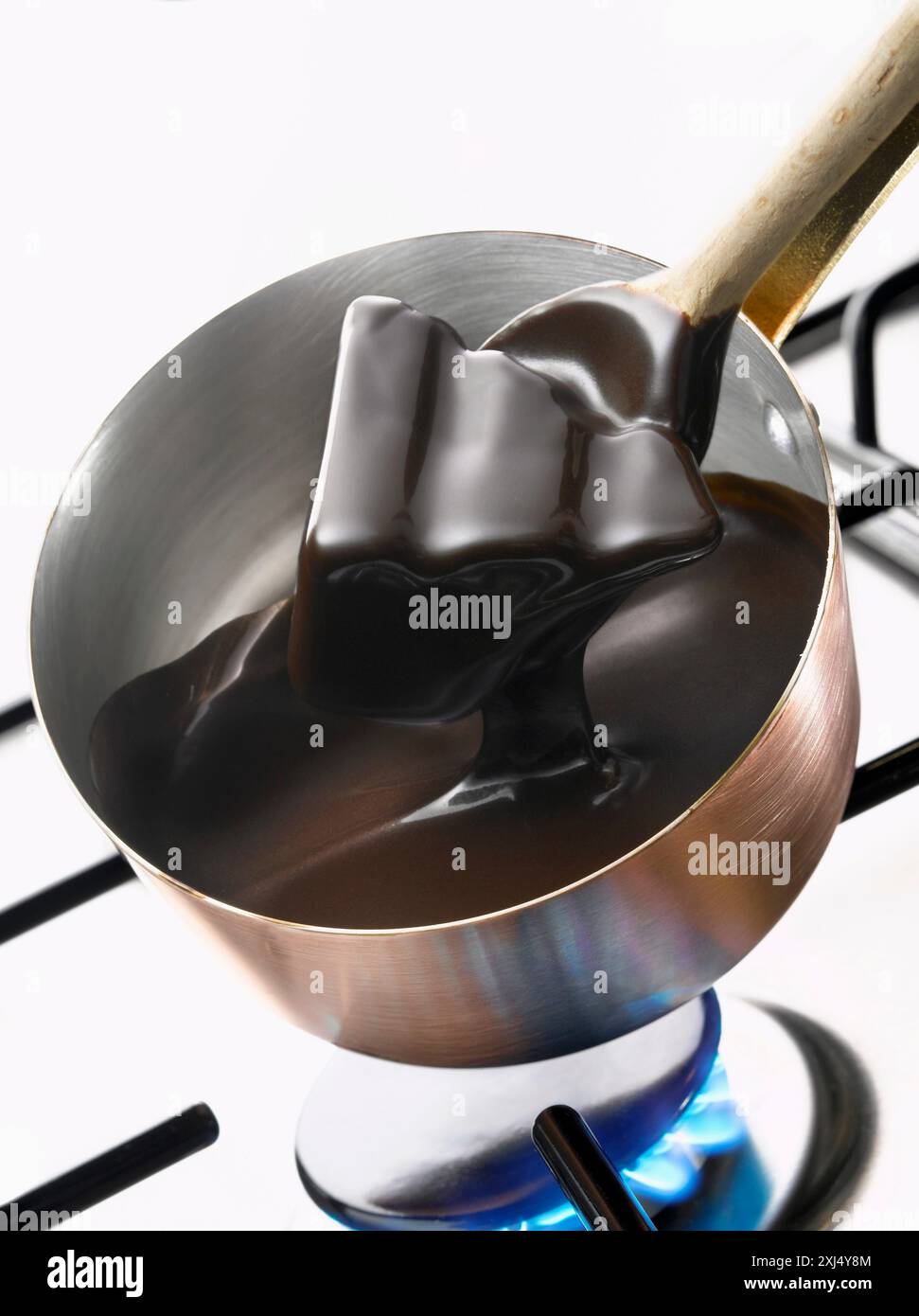 Melting dark chocolate in a copper saucepan Stock Photo - Alamy