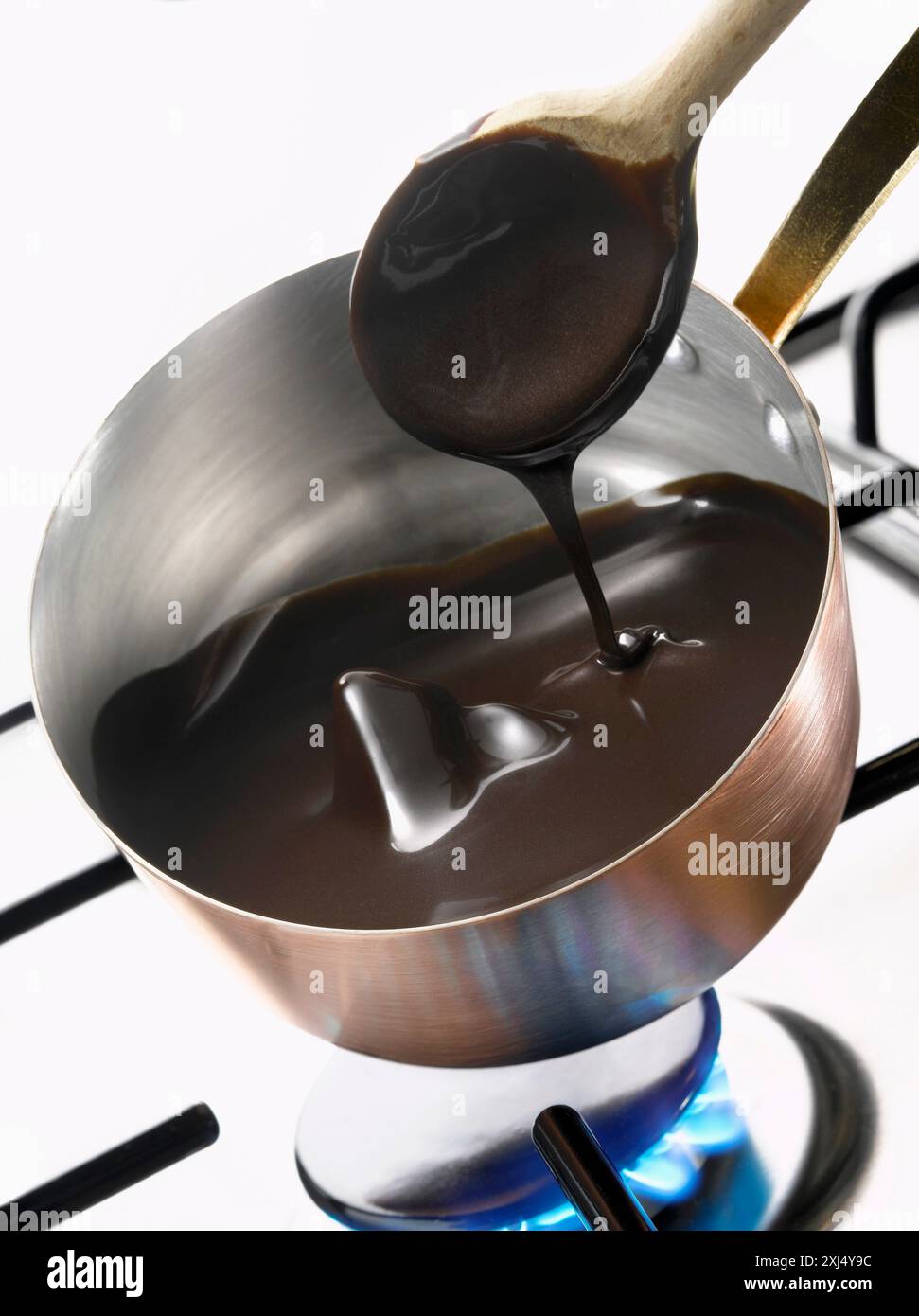 Melting dark chocolate in a copper saucepan Stock Photo - Alamy