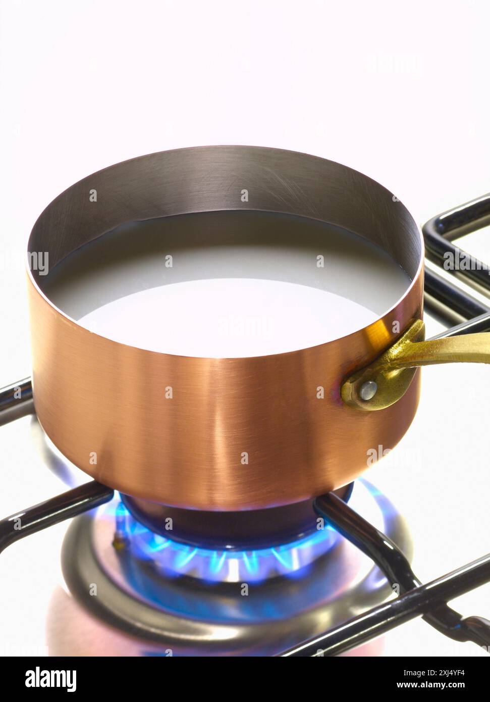 Saucepan of milk on a gas cooker Stock Photo - Alamy