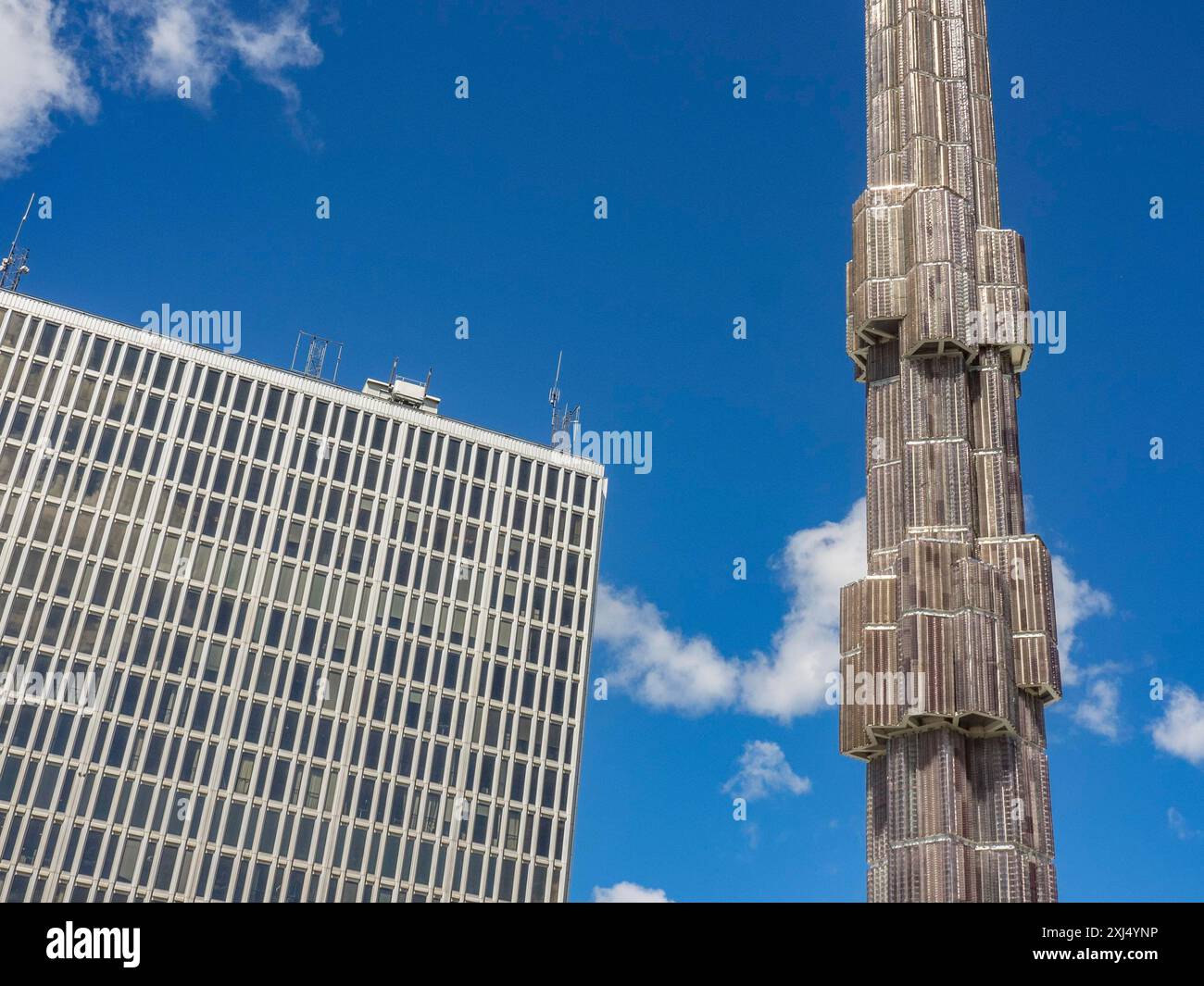 Monument and modern office building under a blue sky in an urban ...