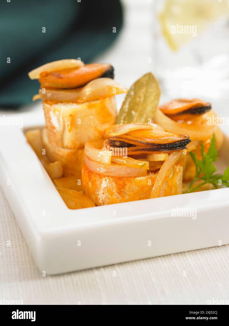 Escabèche mussels on a bite-size slice of bread Stock Photo - Alamy