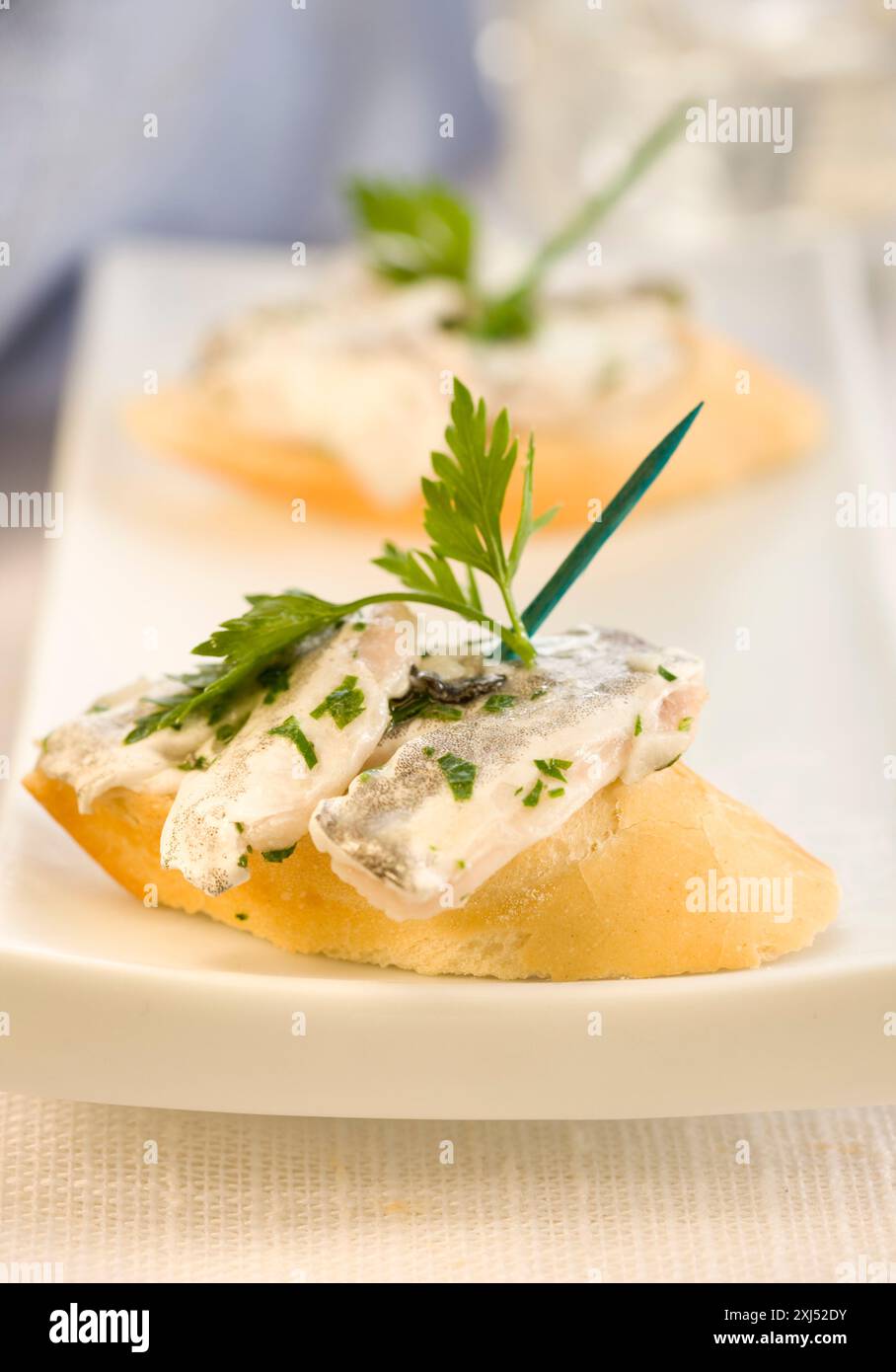 Cod on herbs on a bite-size slice of bread Stock Photo - Alamy