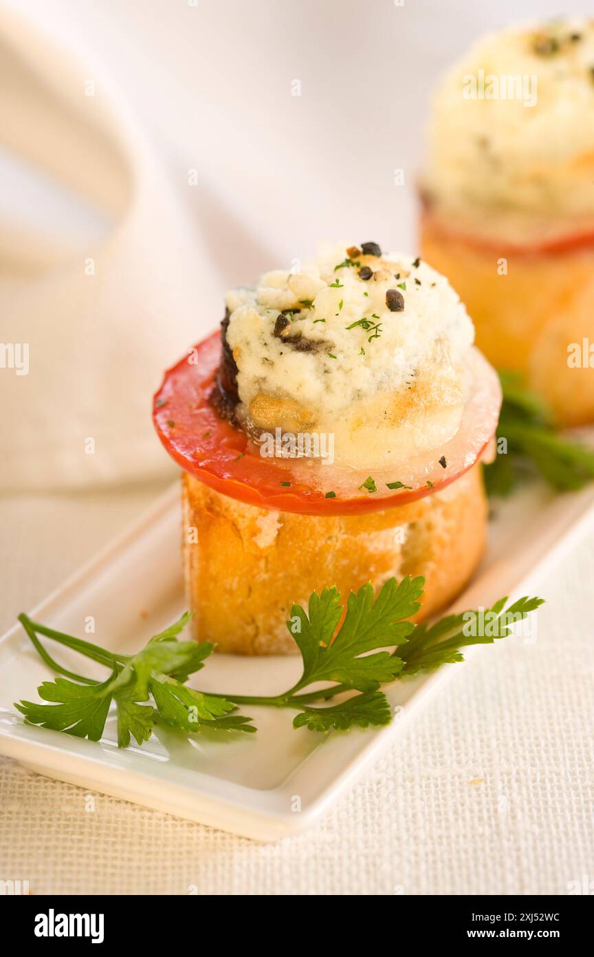 Blood sausage and goat's cheese on a bite-size slice of bread Stock ...