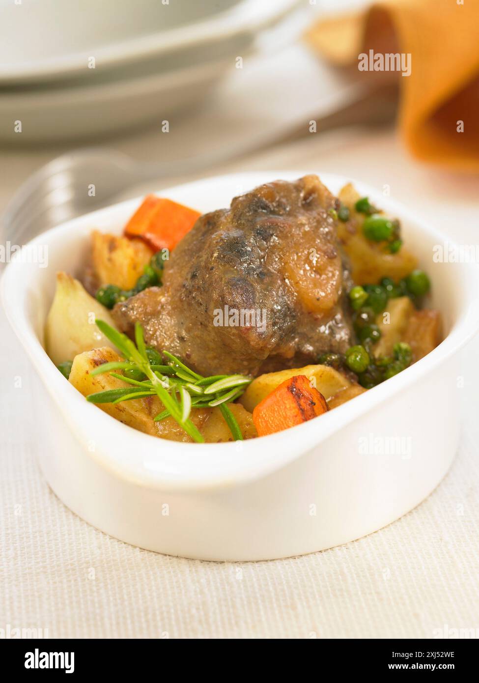 Small casserole dish of bull's tail with carrots and peas Stock Photo ...