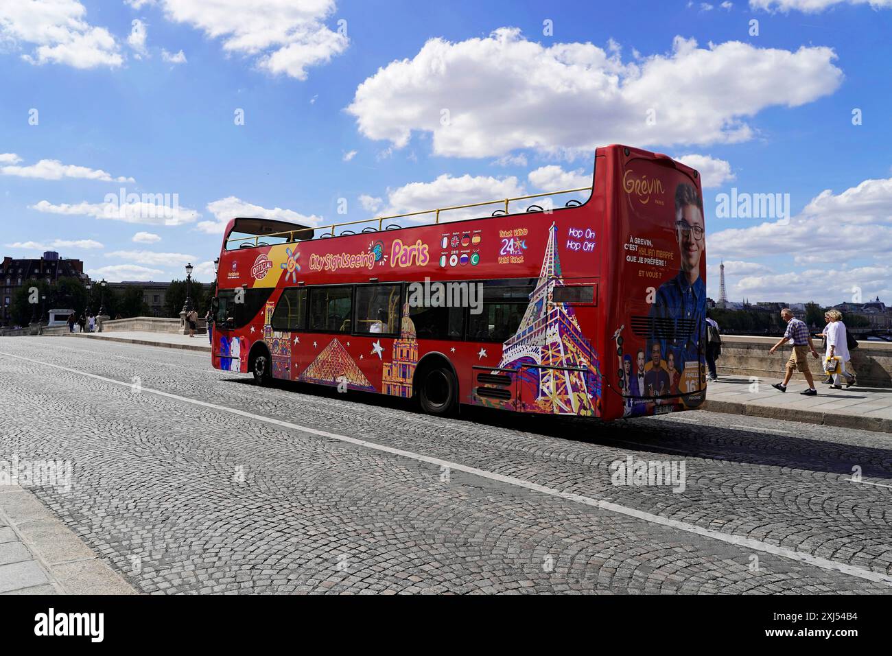 Red double-decker bus for sightseeing tours in Paris drives on a ...