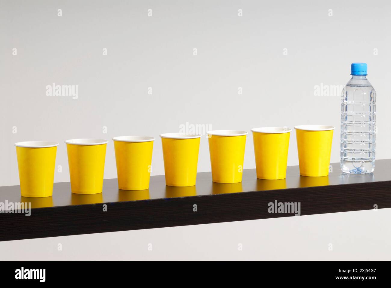 Plastic cups and bottle of water Stock Photo - Alamy