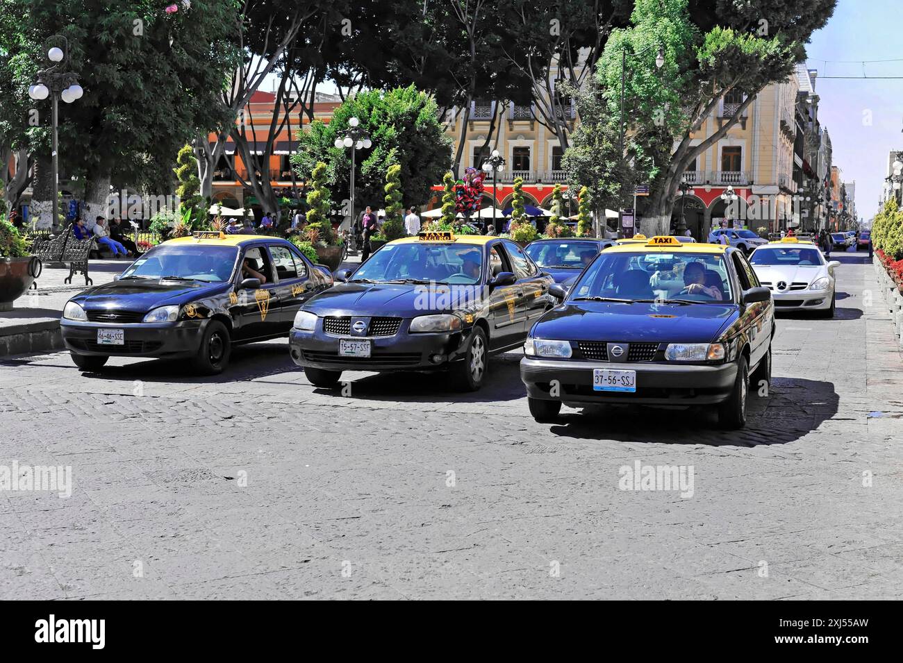 Puebla, Mexico, Central America, Several taxis driving on a city street ...