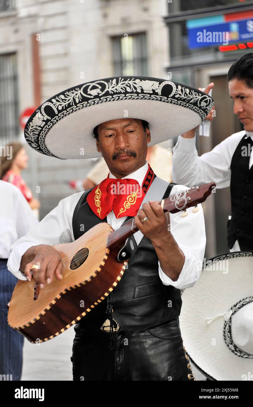 Madrid, Spain, Europe, Man in traditional Mexican dress playing guitar ...