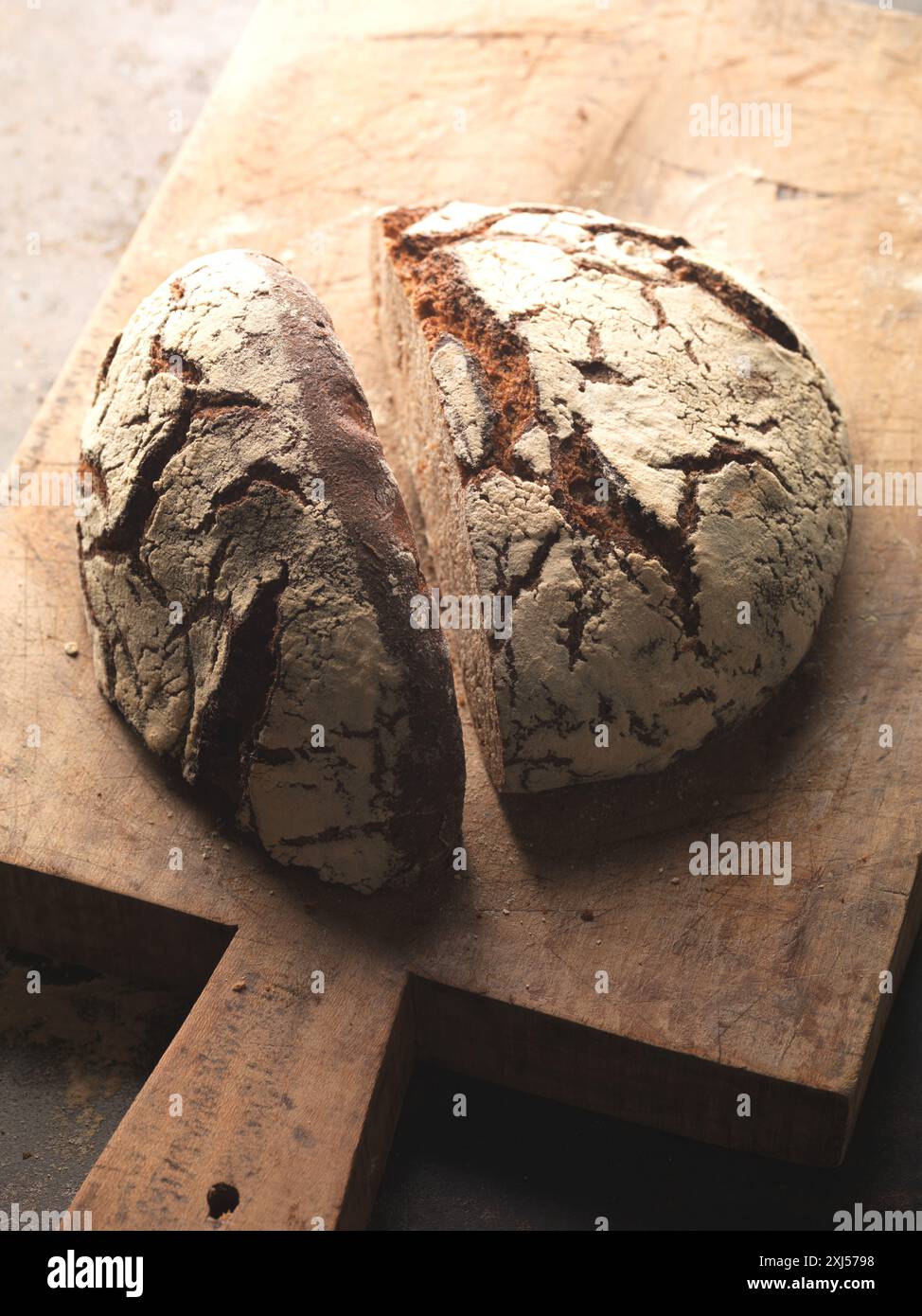 Round loaf of bread cut in half Stock Photo - Alamy