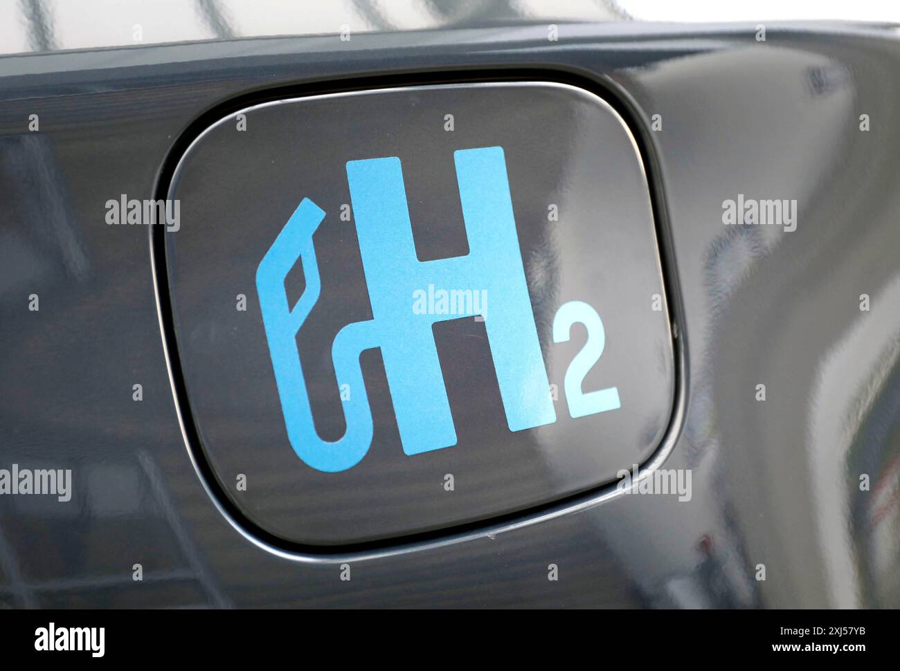 Filler cap with H2 logo of a fuel cell vehicle at a hydrogen filling ...