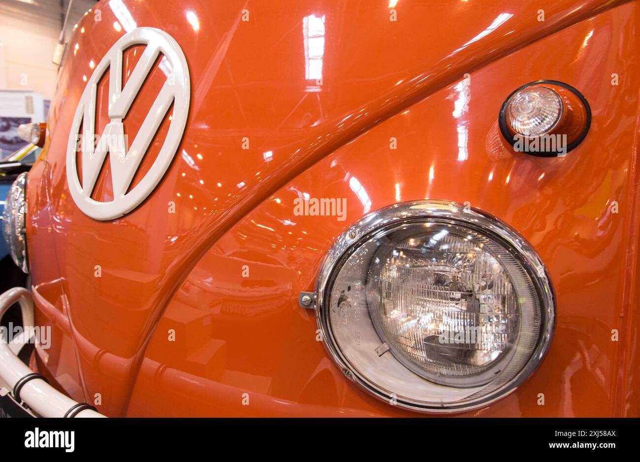 The front end of a Volkswagen bus with large VW logo, indicators and ...