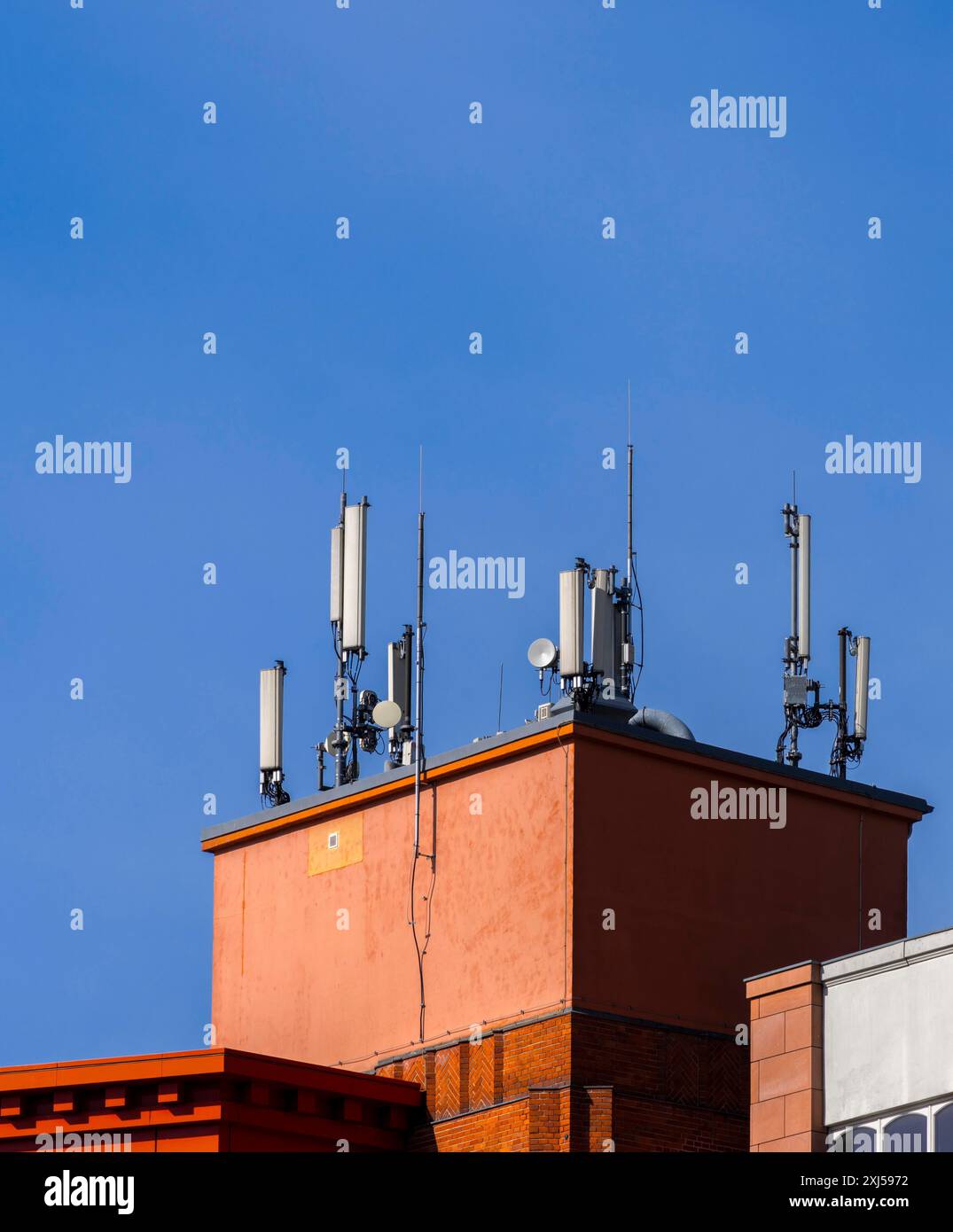 Transmission masts and mobile phone antennas on a rooftop, Berlin ...