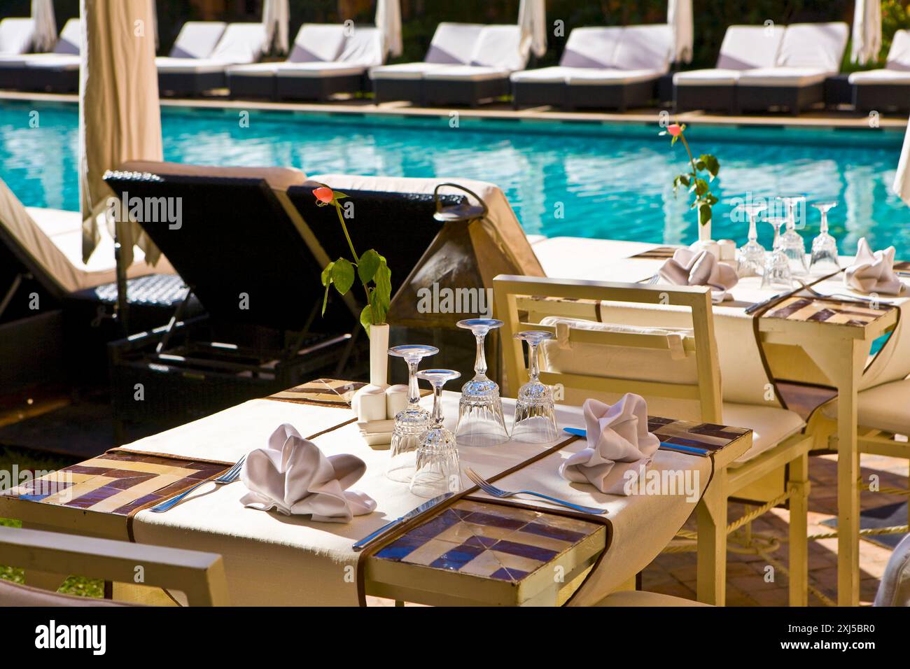 Layed tables by the pool Stock Photo - Alamy