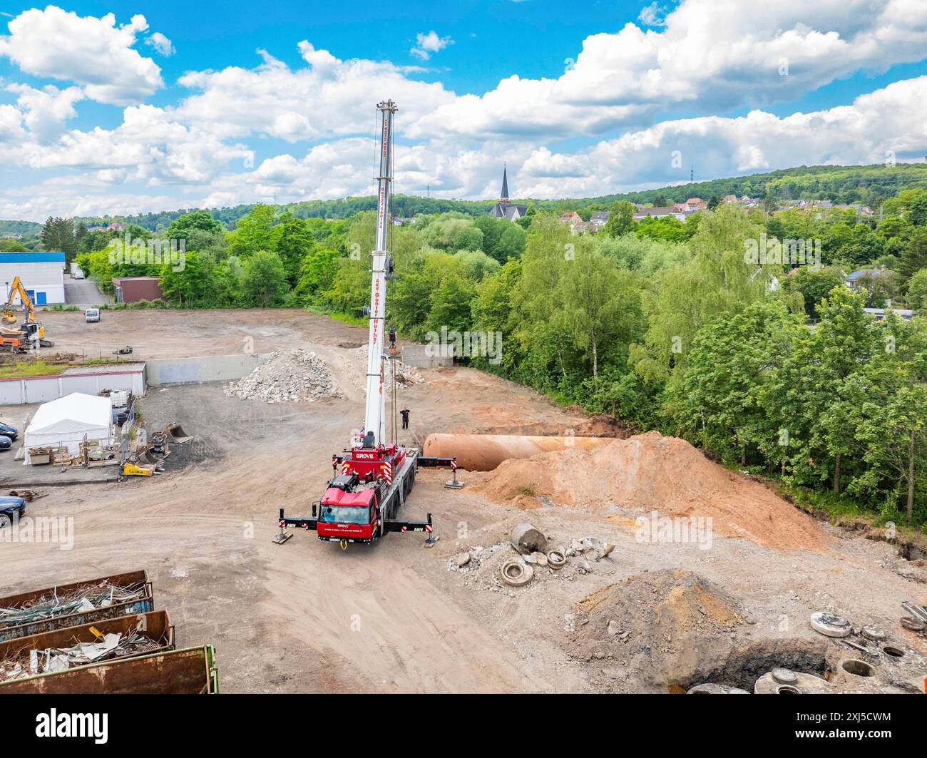 View from above of a construction site with a crane and piles of gravel ...