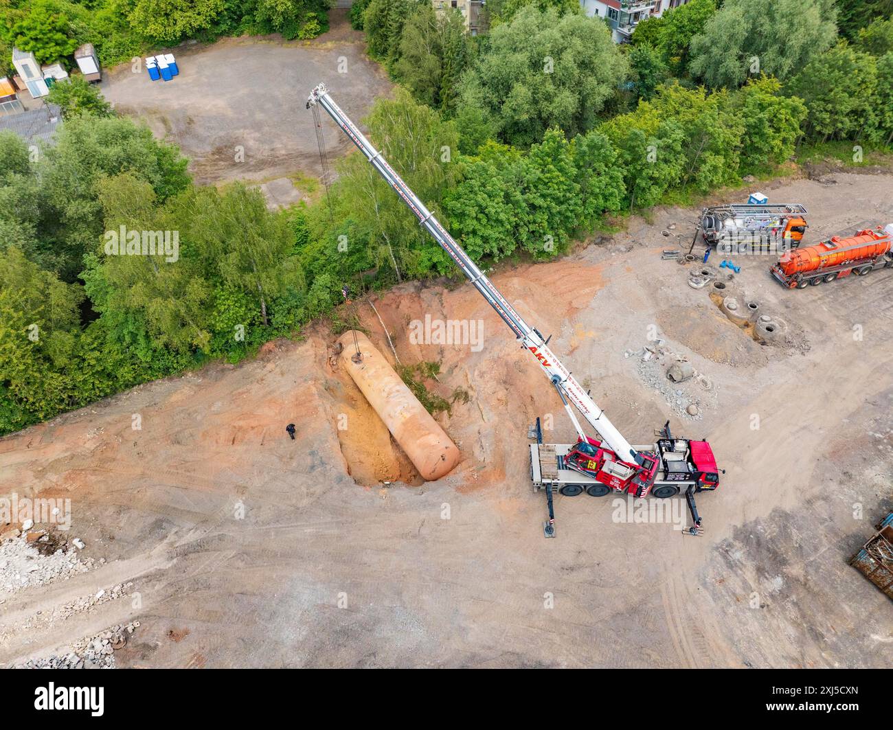 Bird's eye view of a construction site with crane and lorry, surrounded ...