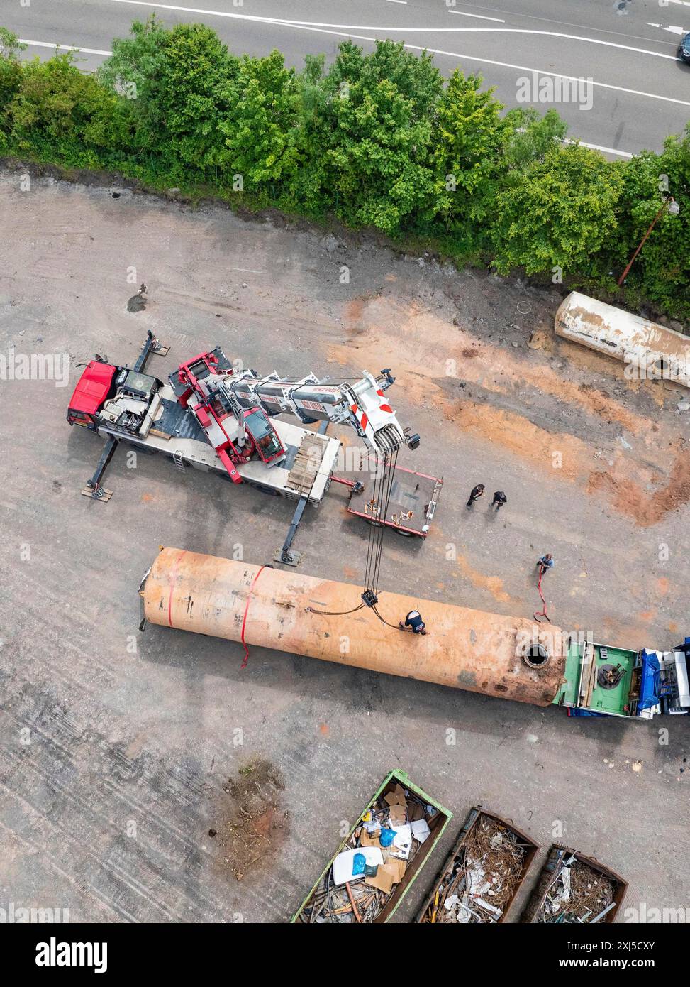 Detailed view of a construction site with a crane and several workers ...