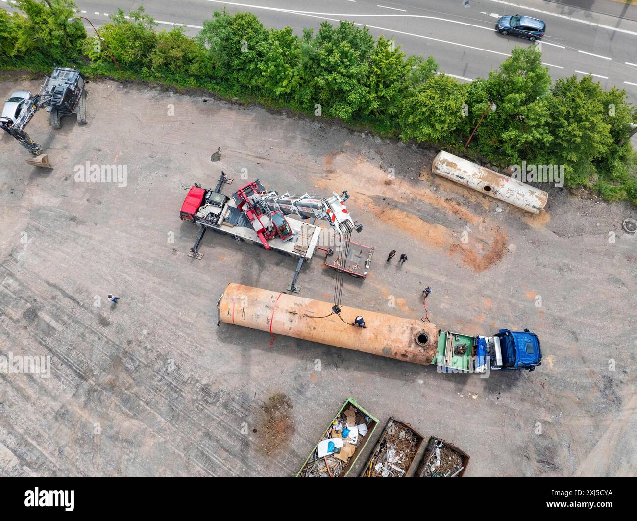 Aerial view of a construction site on a road with a crane and several ...