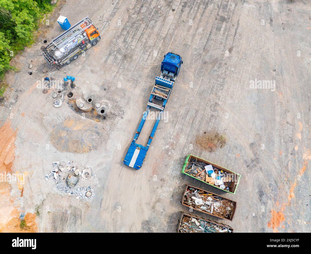 Aerial view of a construction site with a lorry and containers full of ...