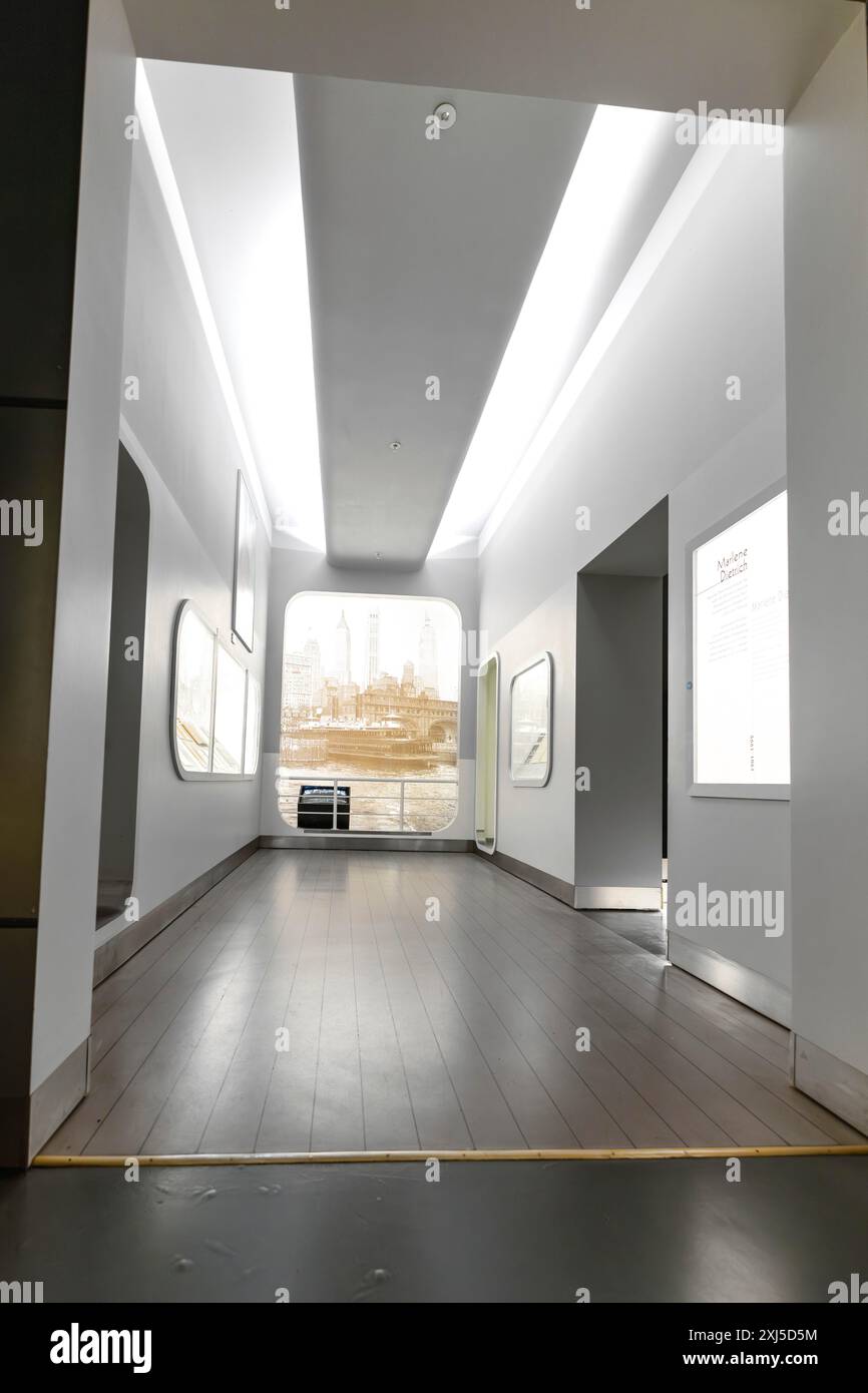 A bright, minimalist interior with high ceilings and large windows that ...