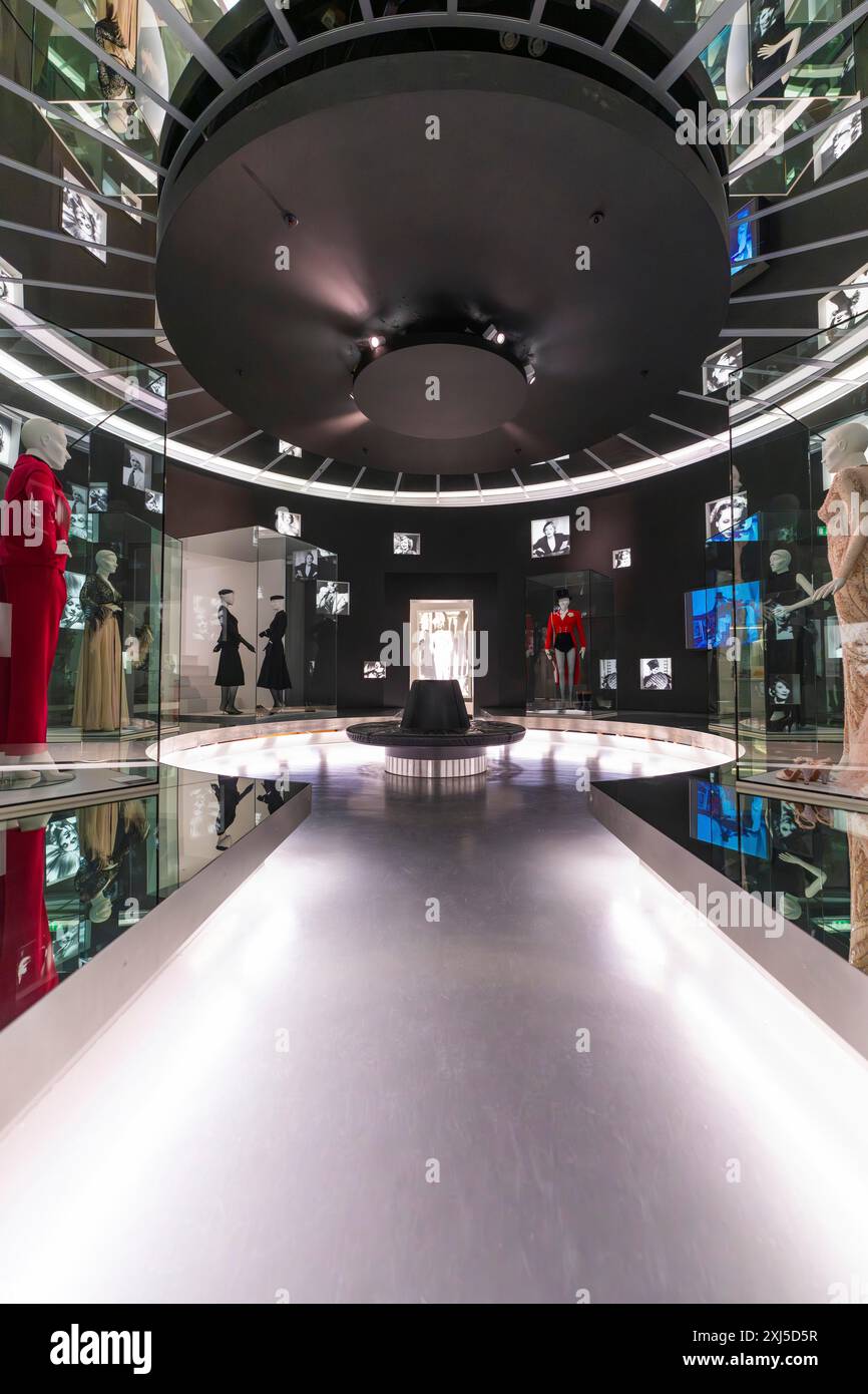 Futuristic exhibition space with illuminated mirrors and mannequins ...