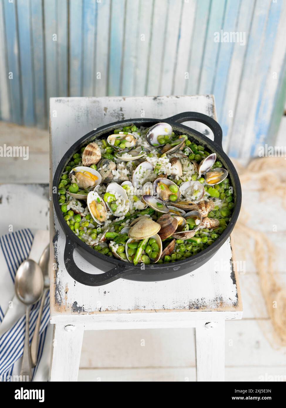 Casserole dish of carpet-shell clams with peas and asparagus Stock ...