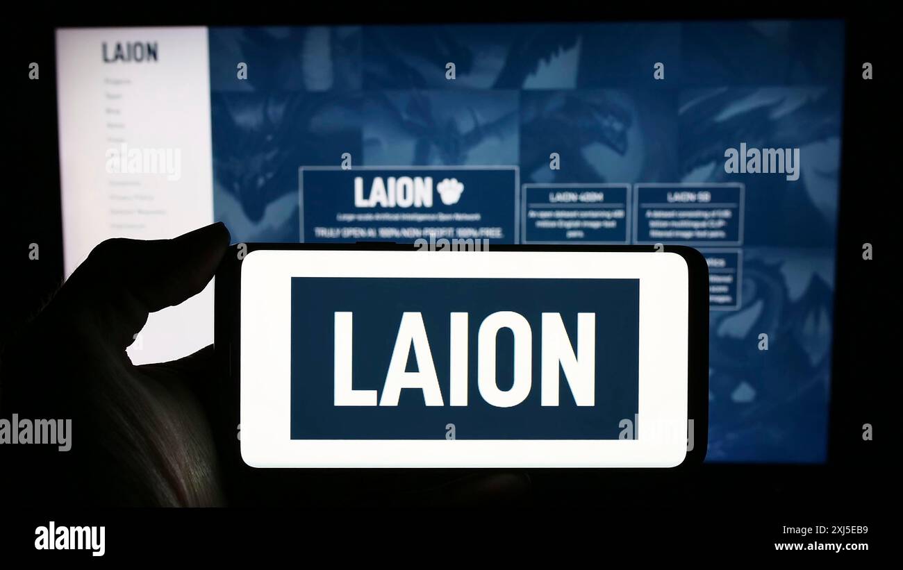 Stuttgart, Germany, 02-15-2024: Person holding mobile phone with logo of Large-scale Artificial ...