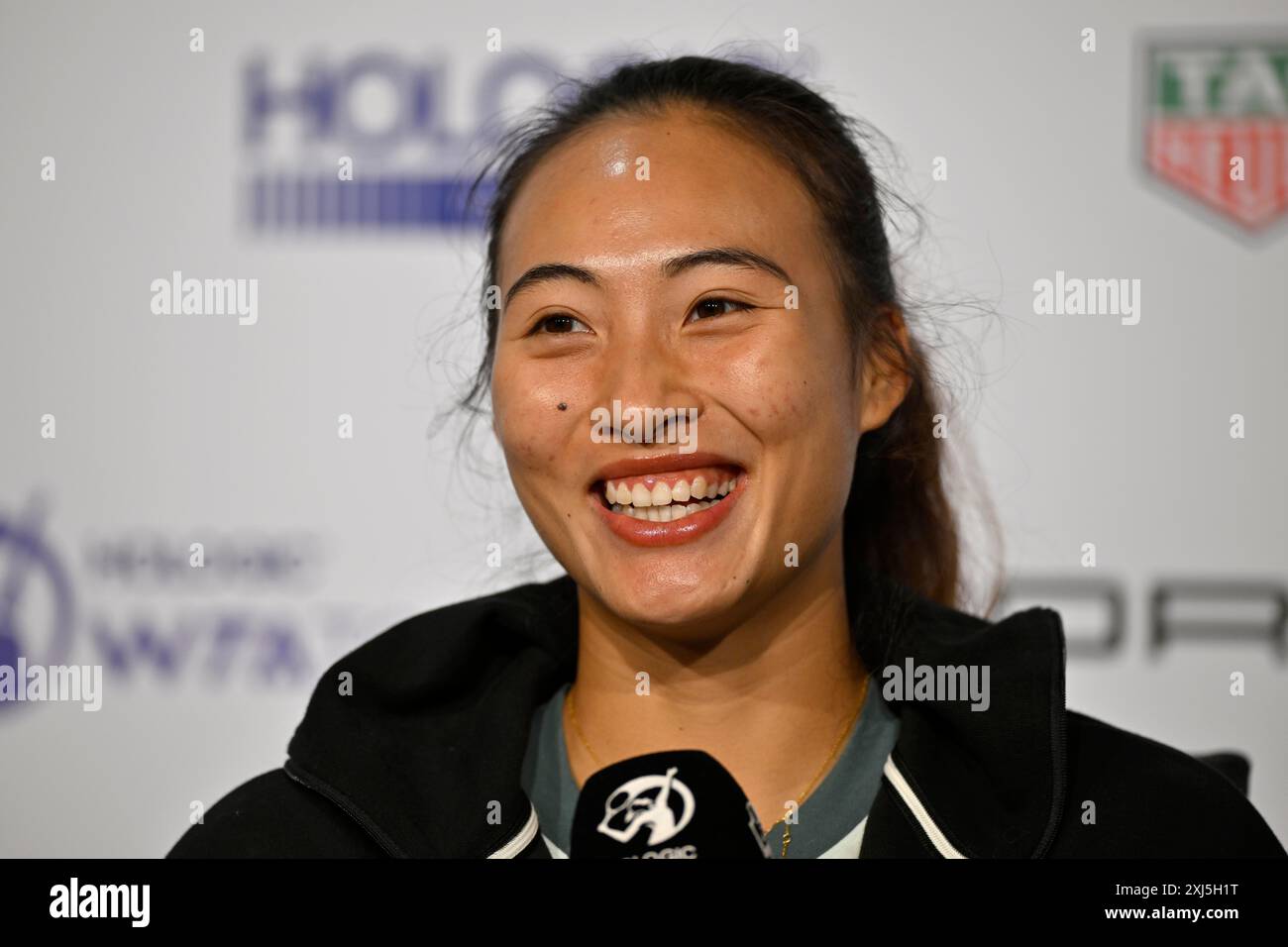 Qinwen Zheng (CHN) portrait, smiles, microphone, mike, logo, WTA, press ...