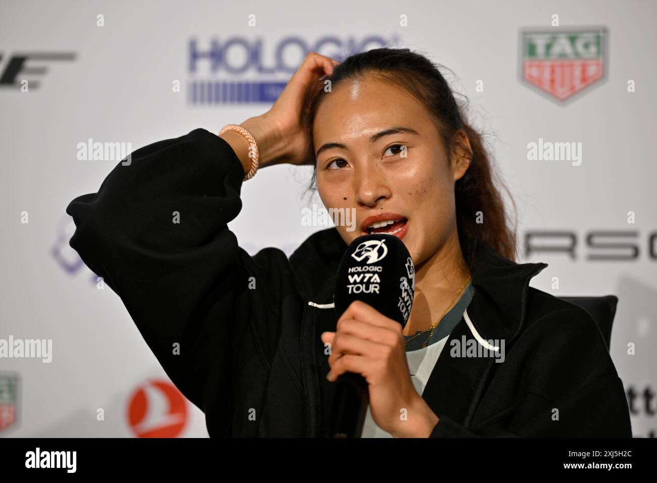 Qinwen Zheng (CHN) portrait, smiles, microphone, mike, logo, WTA, press ...