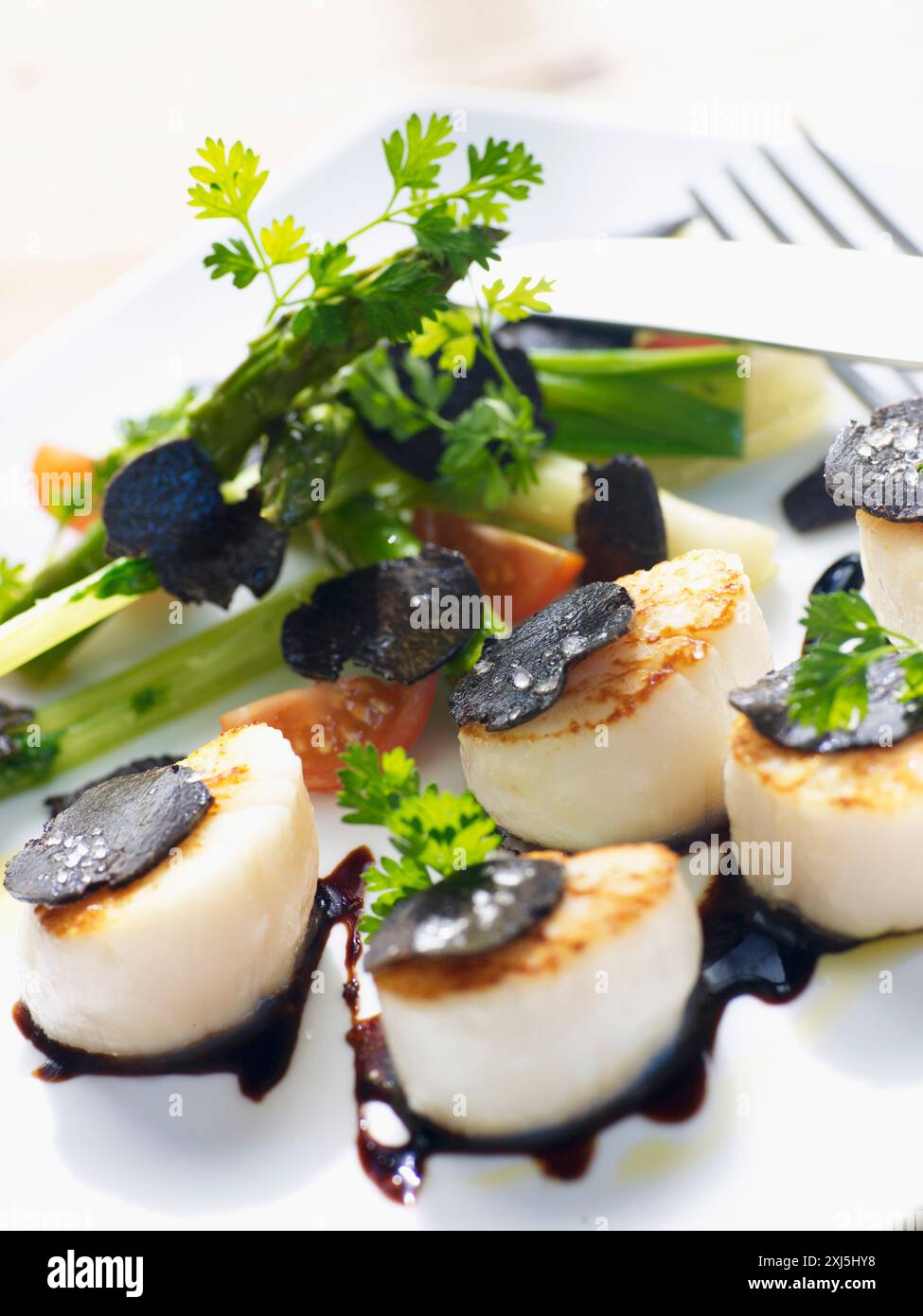 Sauteed scallops with truffles Stock Photo - Alamy