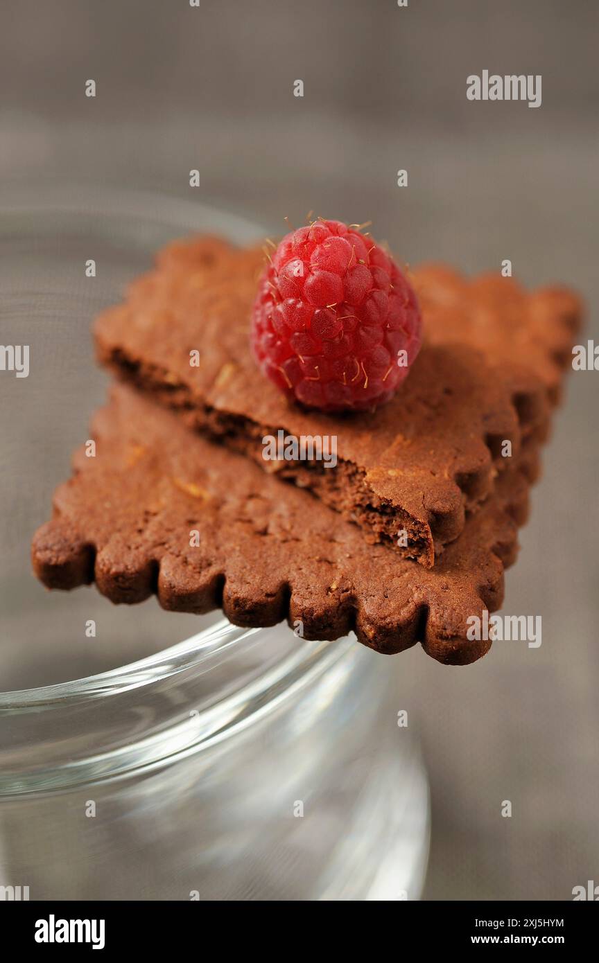 Organic chocolate biscuit and a raspberry Stock Photo - Alamy