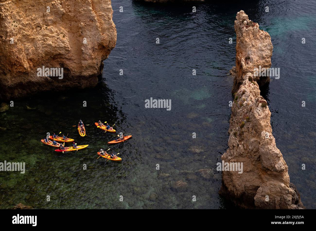 Kayaker, kayaks, kayaking, guided tour through grottos, rocks in the ...