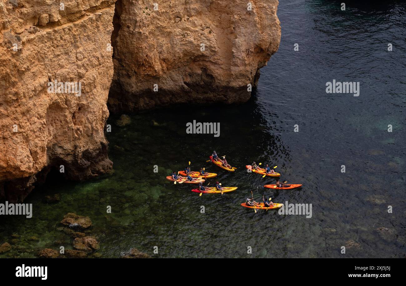 Kayaker, kayaks, kayaking, guided tour through grottos, rocks in the ...