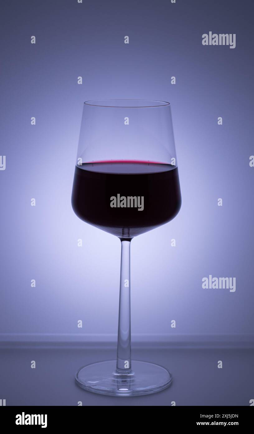 A generous glass of red wine. Clean details in a white background ...