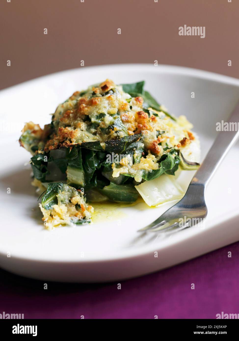 Swiss chard and Tomme de Savoie cheese-topped dish Stock Photo - Alamy